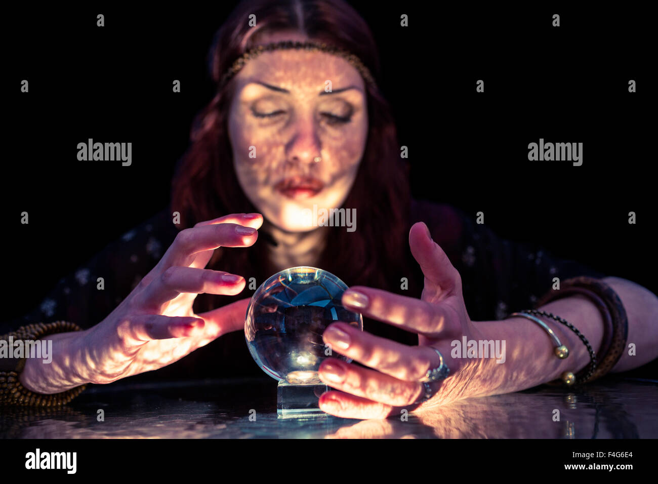 Young woman using crystal ball hi-res stock photography and images - Alamy