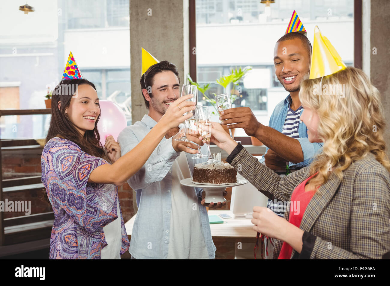 Happy colleagues toasting during celebration Stock Photo - Alamy