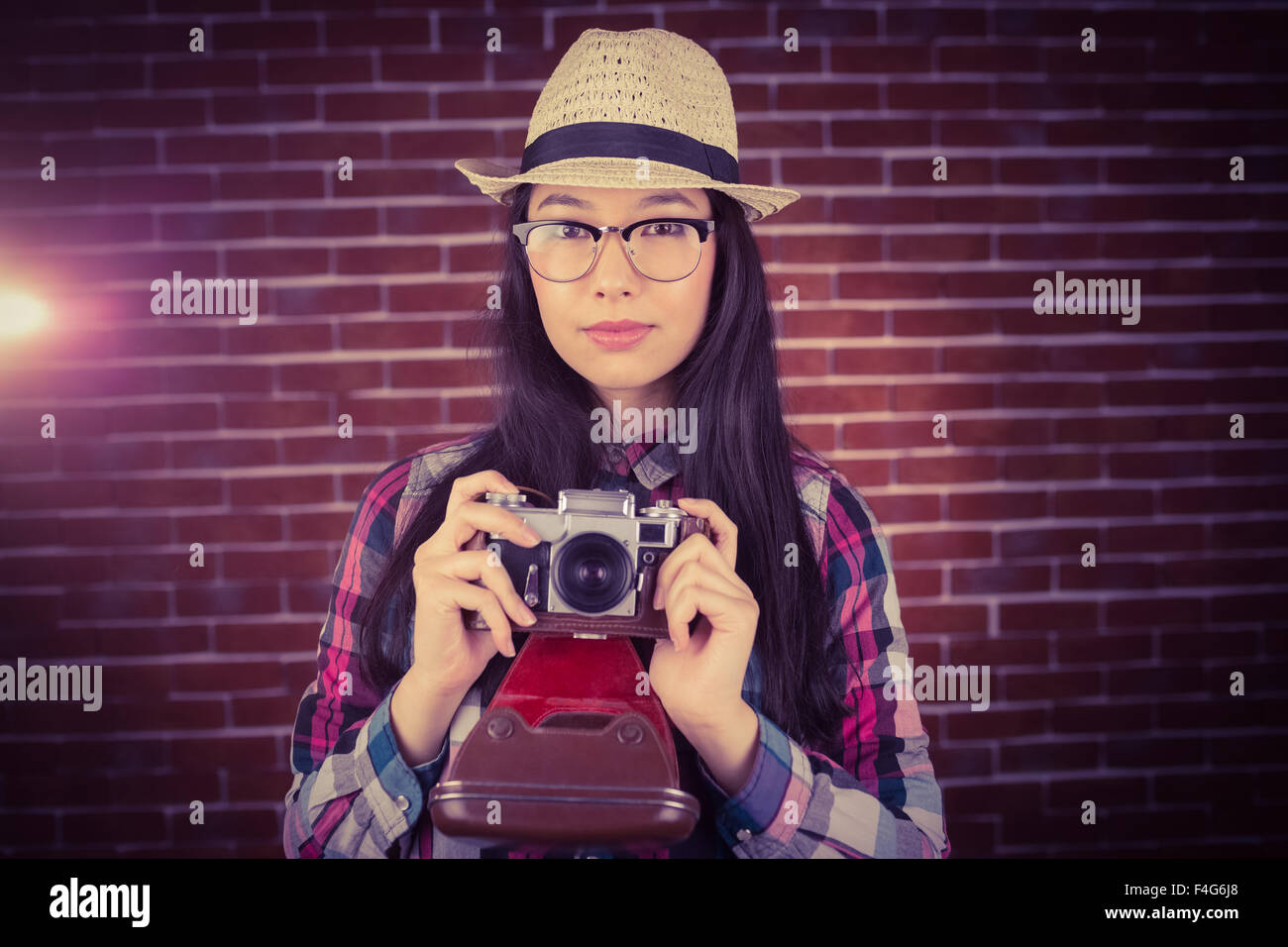 Attractive hipster holding a camera Stock Photo - Alamy