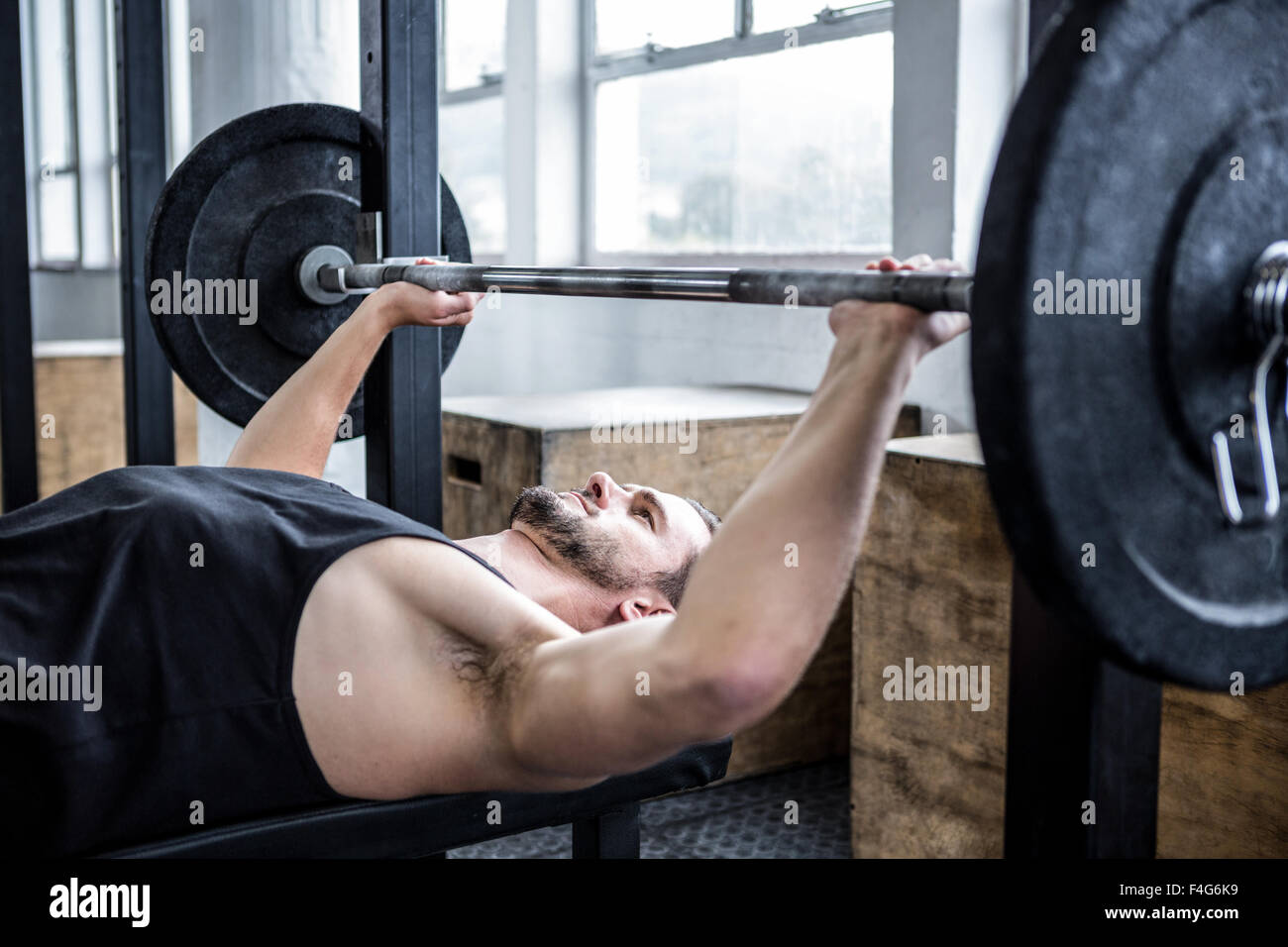 Fit man lifting heavy barbell Stock Photo - Alamy