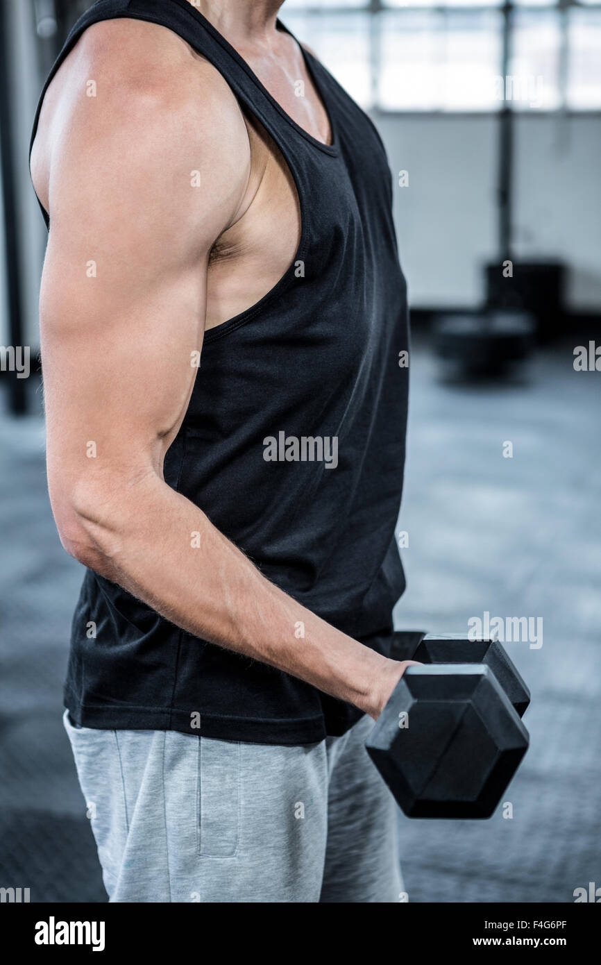 Fit man lifting heavy black dumbbells Stock Photo - Alamy