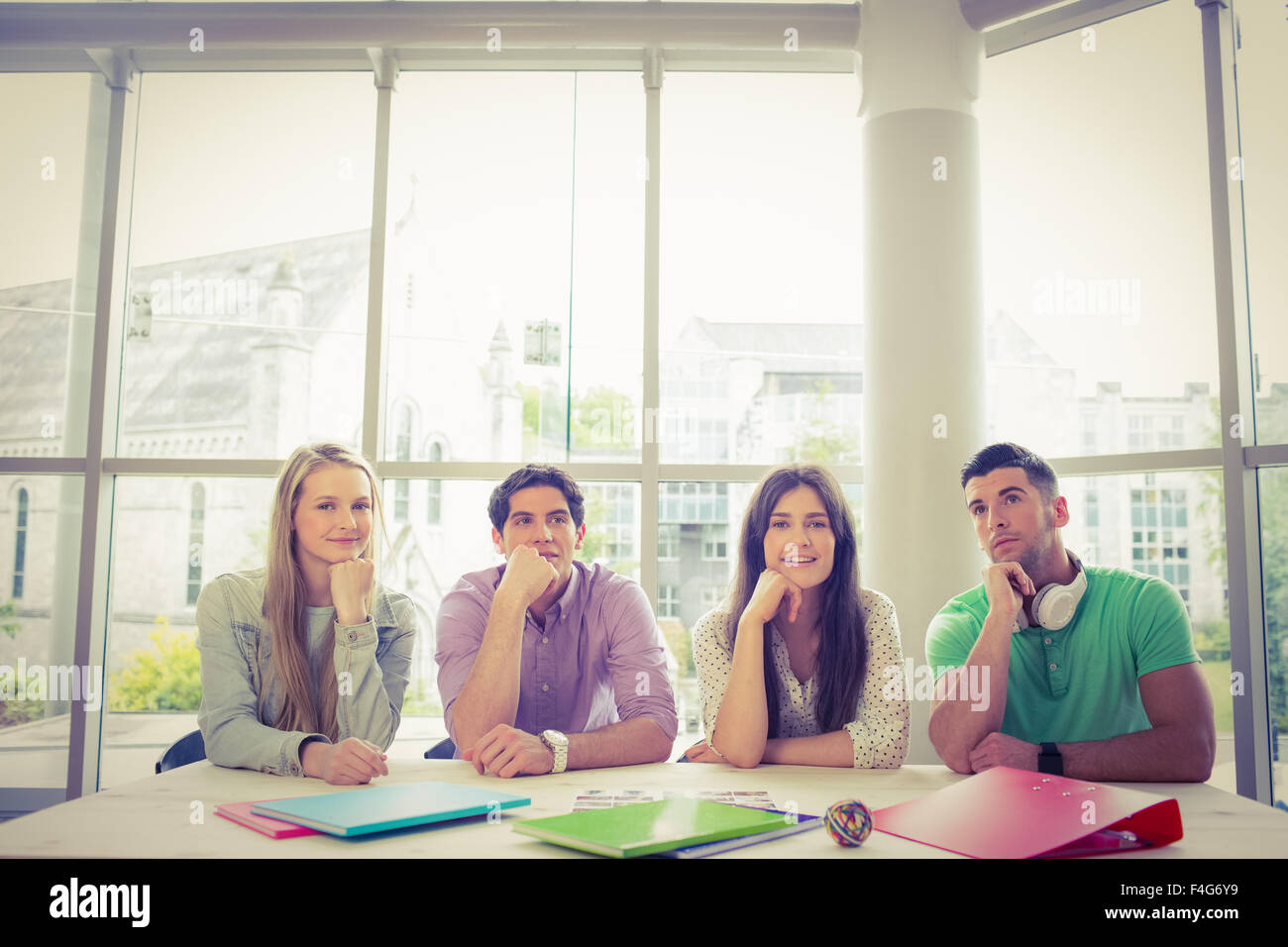 Students thinking at a desk Stock Photo - Alamy
