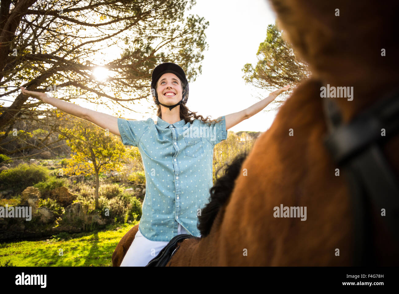 Young woman riding her horse Stock Photo - Alamy