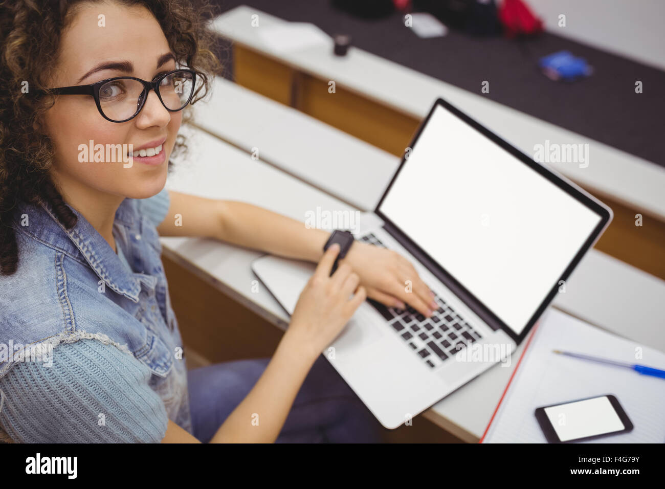 Pretty student in lecture hall with smartwatch Stock Photo - Alamy