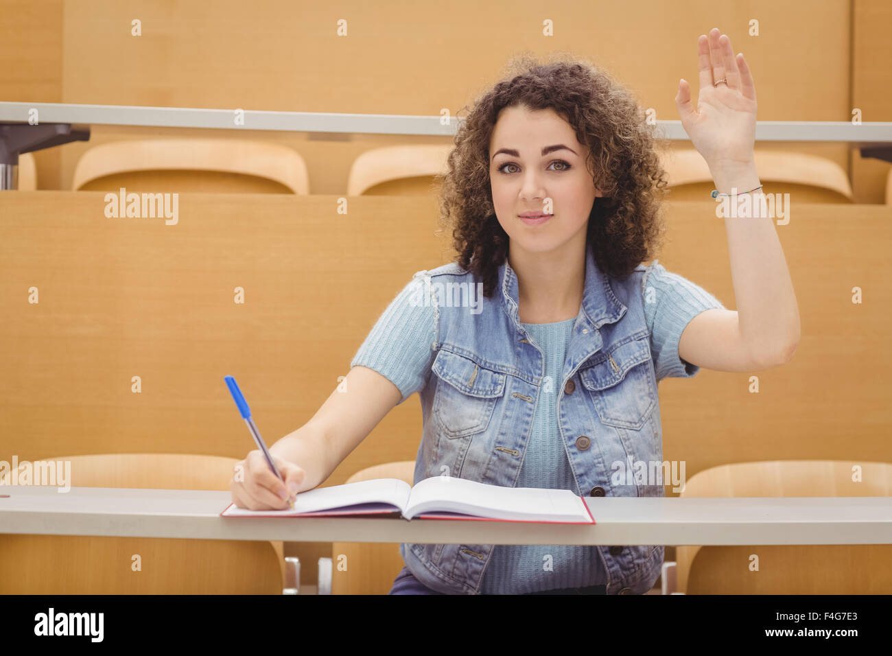 Student raising hand in lecture Stock Photo - Alamy