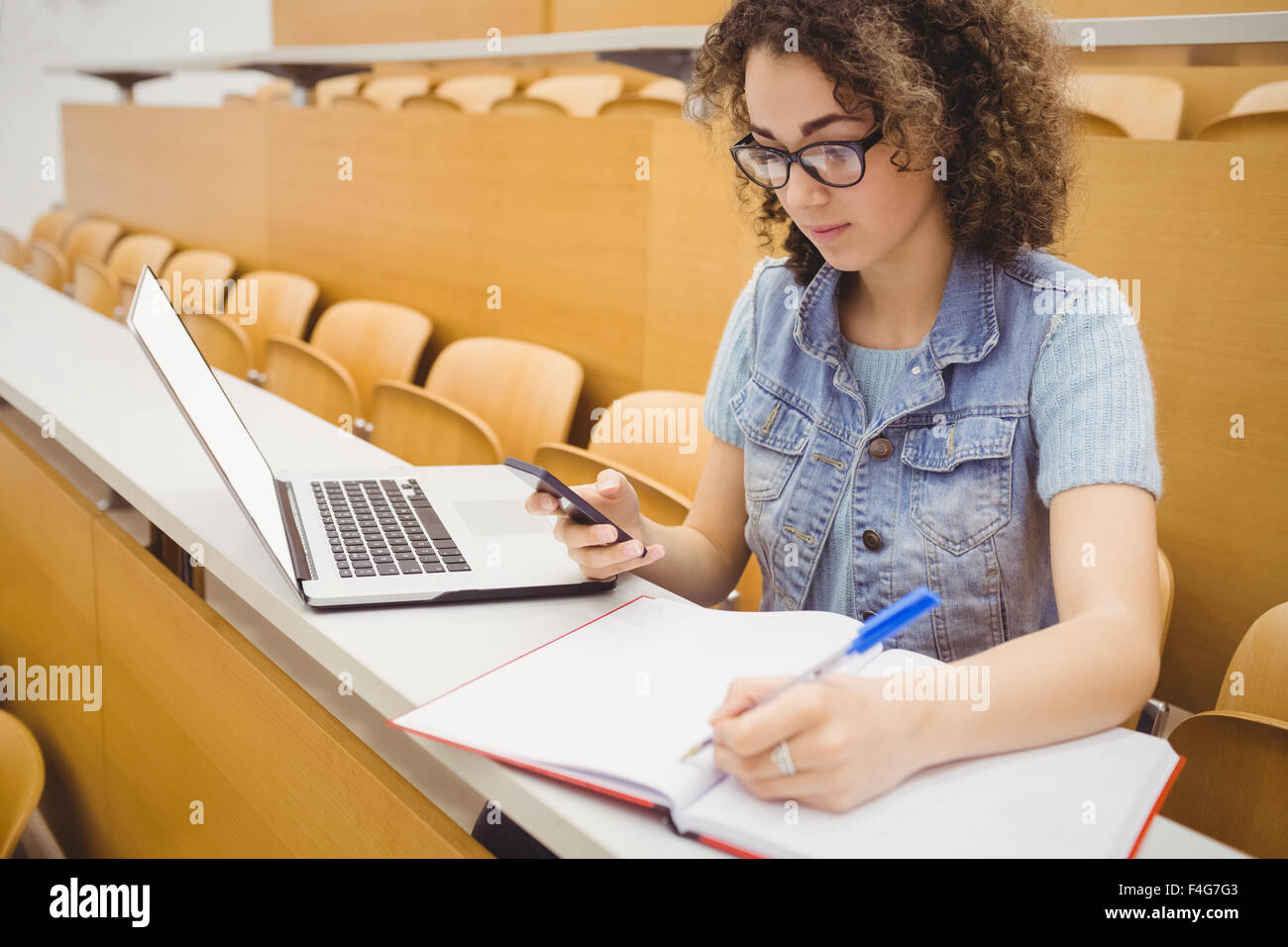 Student sitting lecture hall holding hi-res stock photography and ...