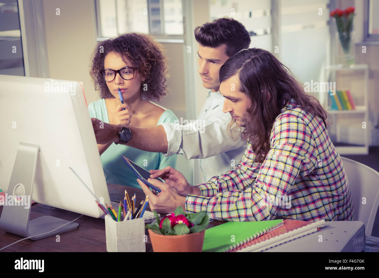 Businessman explaining to colleague on computer Stock Photo - Alamy