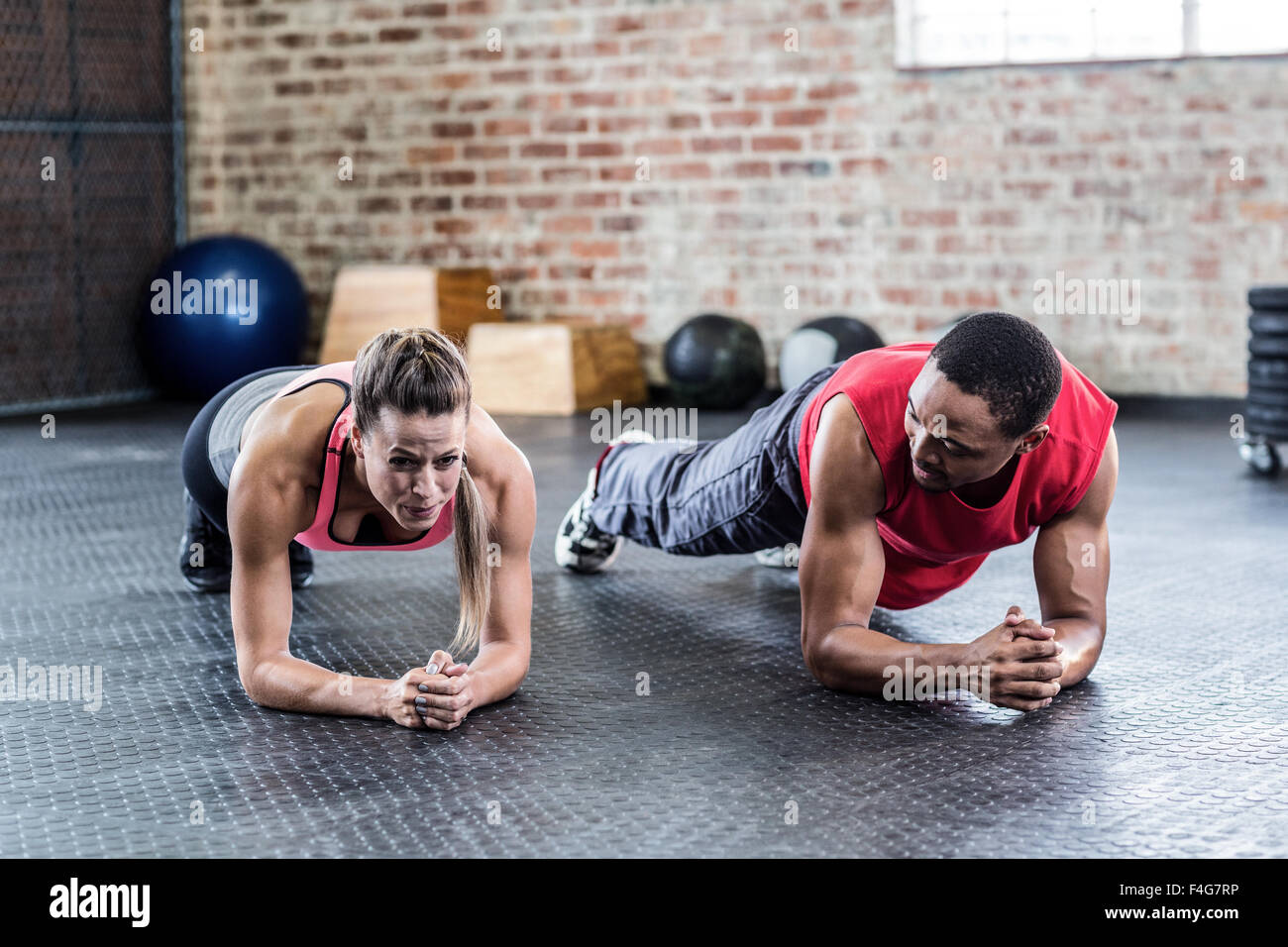 Fit couple doing plank exercises together Stock Photo - Alamy
