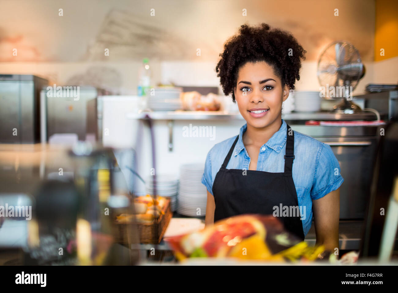 Pretty waitress smiling at camera Stock Photo - Alamy