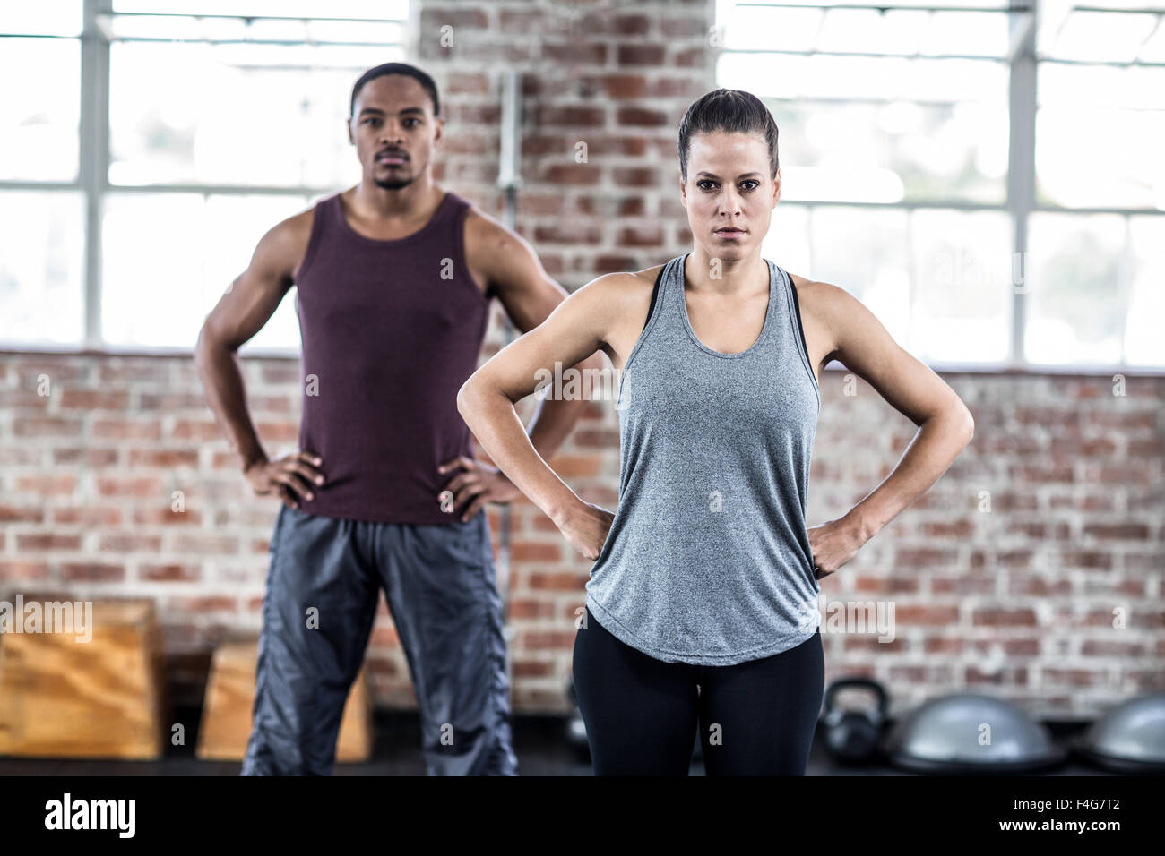 Fit couple posing with hands on hips Stock Photo - Alamy