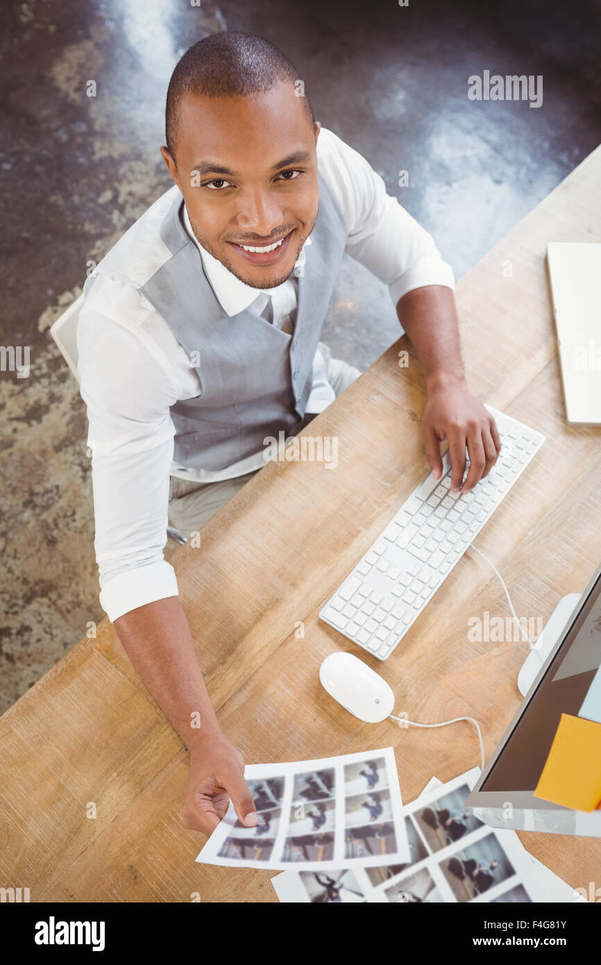Smiling businessman holding photographs Stock Photo - Alamy