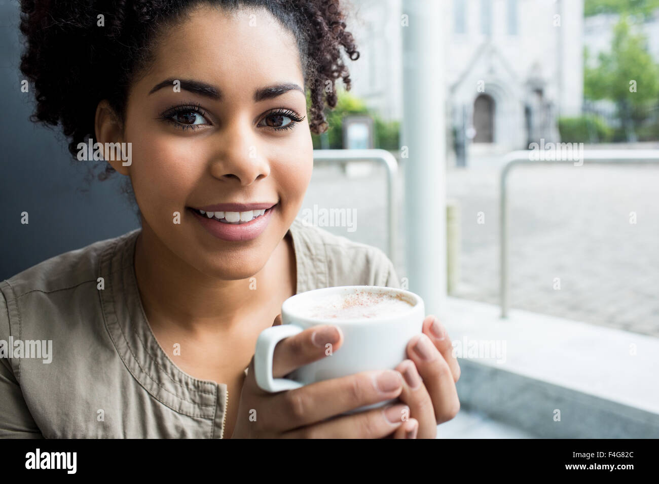 Pretty student having a coffee Stock Photo - Alamy