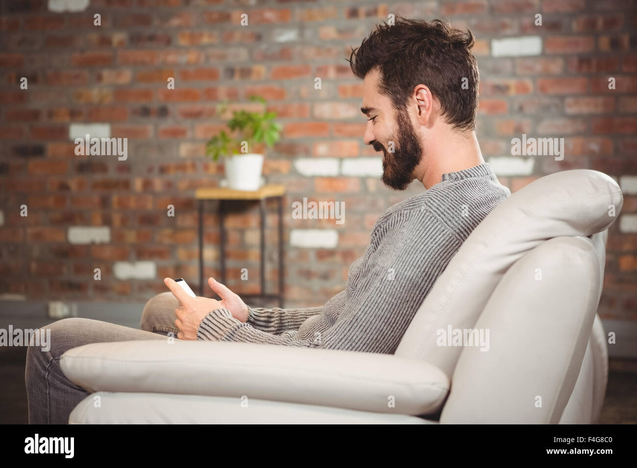 Side view of happy man using smartphone Stock Photo - Alamy