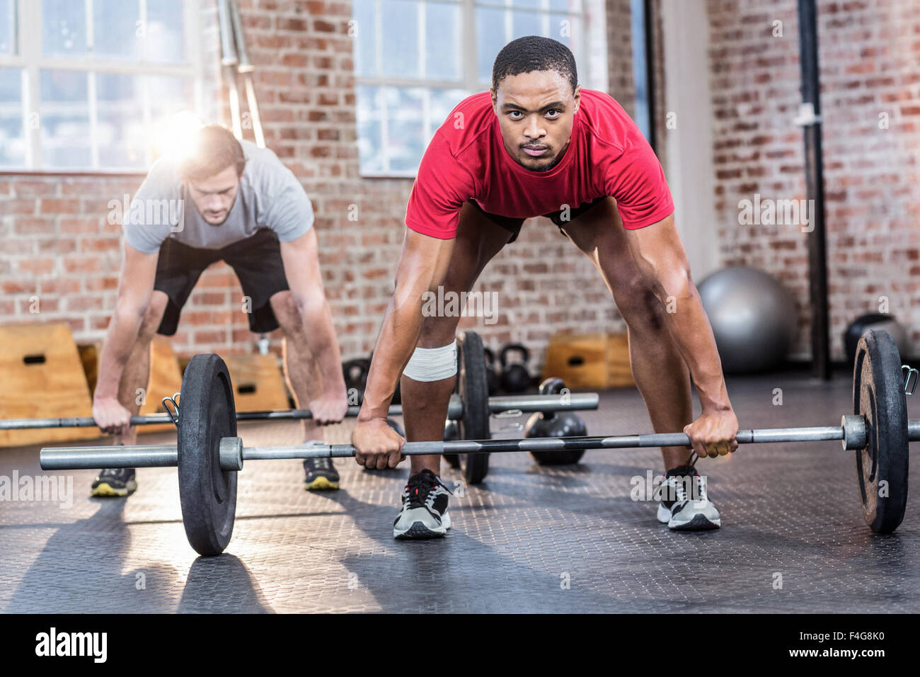 Fit people lifting a barbell Stock Photo - Alamy