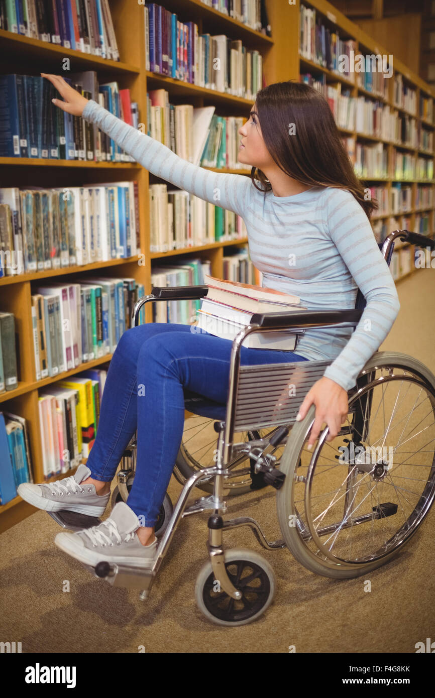 Disabled female student selecting book from shelf Stock Photo - Alamy Disabled female student selecting book from shelf Stock Photo - Alamy