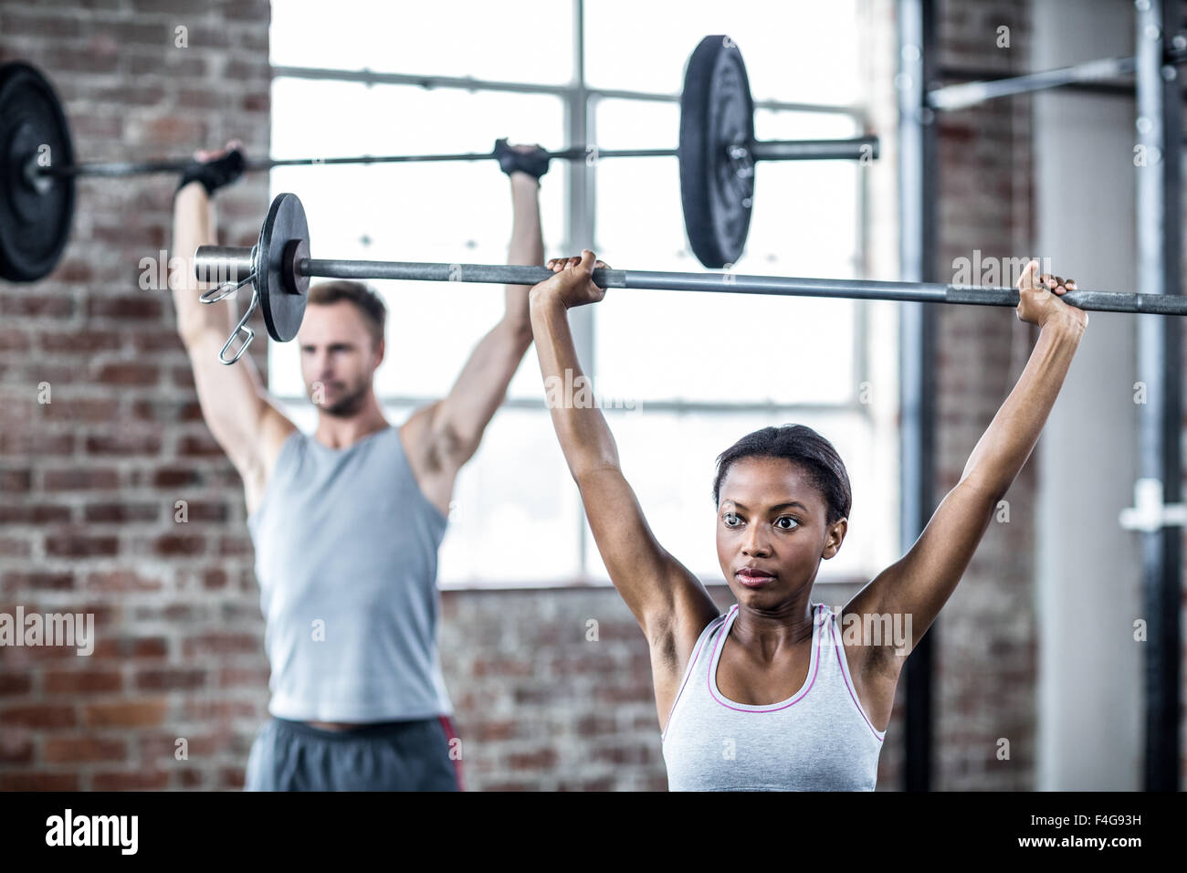 Fit couple lifting weight together Stock Photo - Alamy