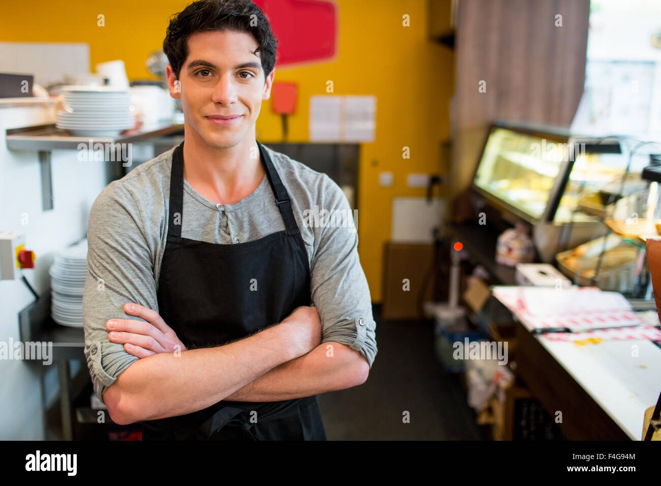 Handsome waiter smiling at camera Stock Photo - Alamy