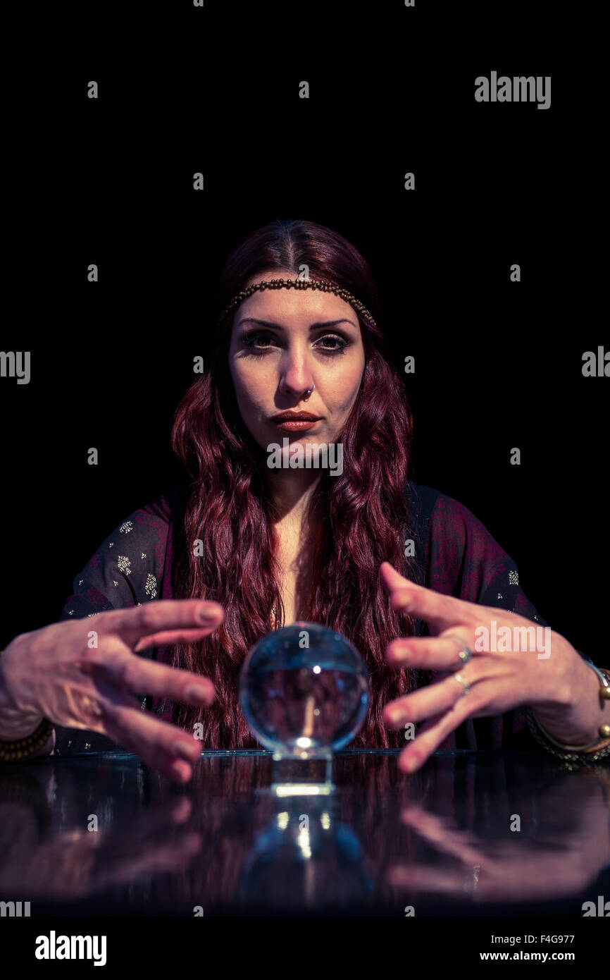 Young woman using crystal ball hi-res stock photography and images - Alamy