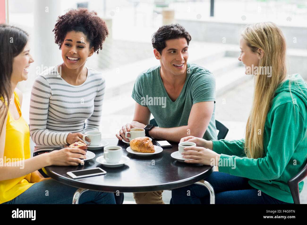 Happy students having coffee together Stock Photo - Alamy
