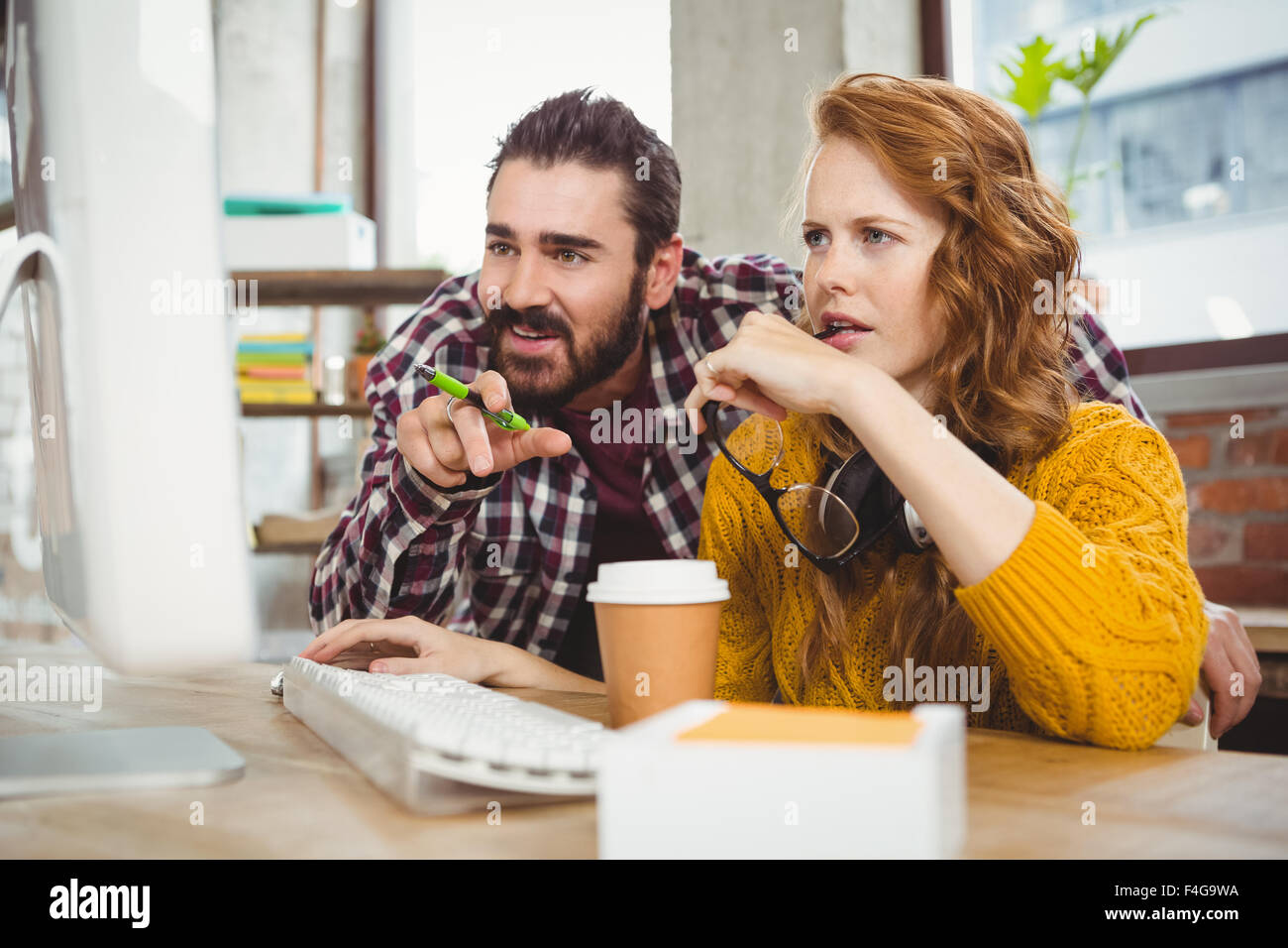 Colleagues concentrating and looking at computer Stock Photo - Alamy