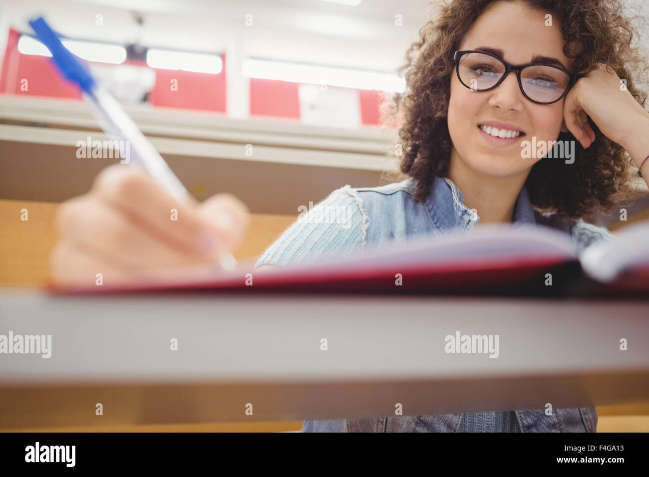 Student taking notes in lecture Stock Photo - Alamy