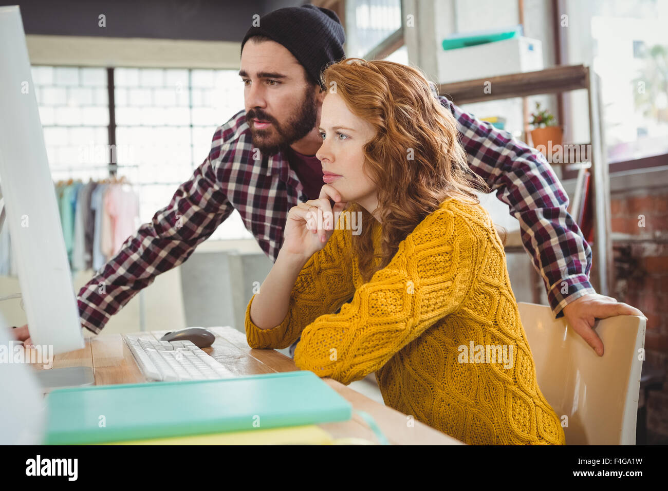 Man and woman looking at computer Stock Photo - Alamy