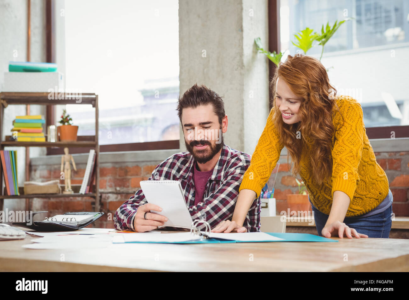 Business people looking at spiral notebook Stock Photo - Alamy