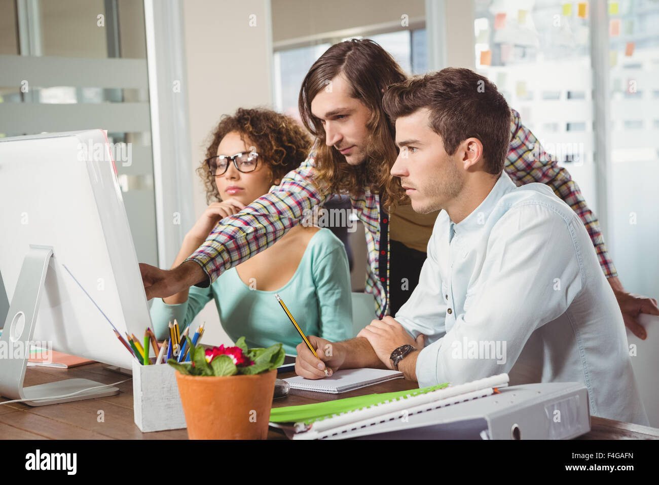 Businessman pointing at computer screen Stock Photo - Alamy