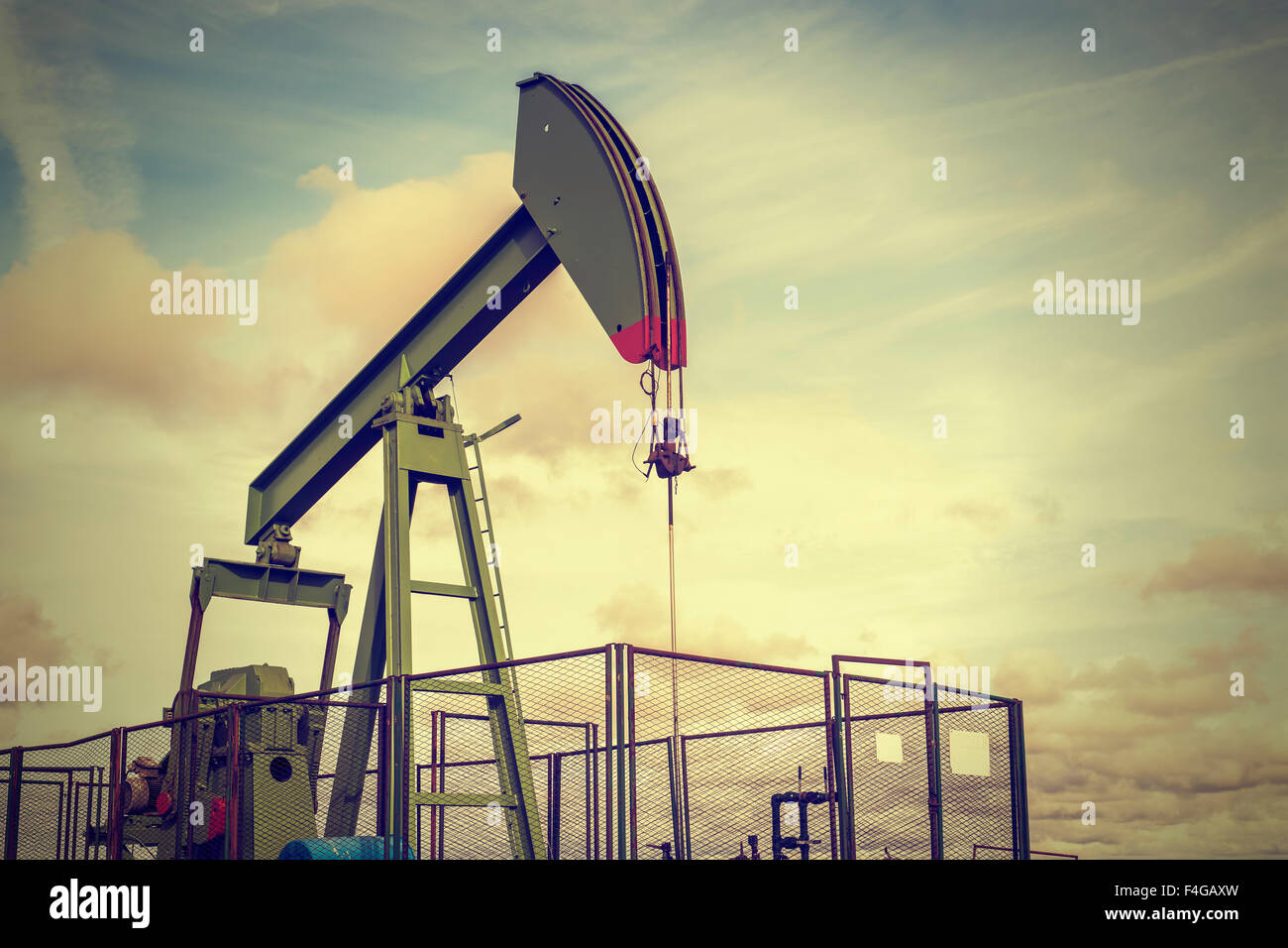 oil rig pumping on cloudy sky background Stock Photo - Alamy