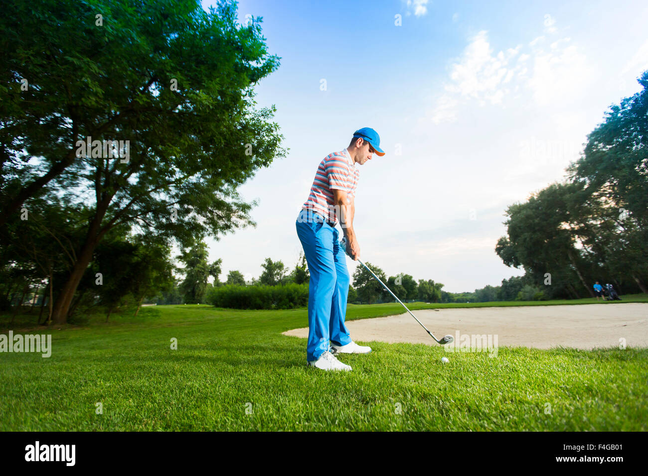 Young man playing golf Stock Photo - Alamy