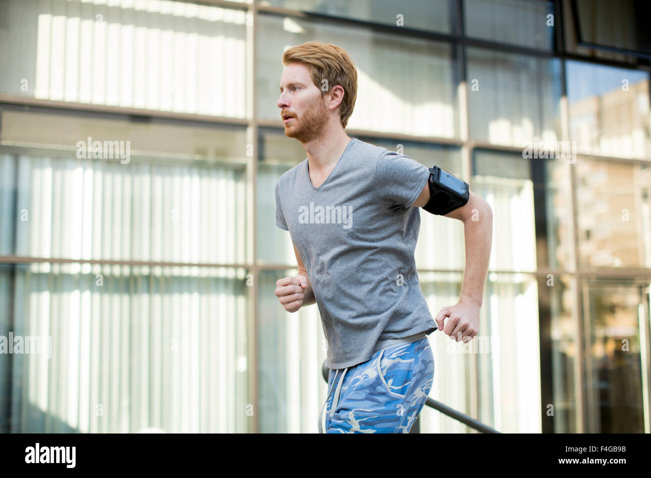 Young man running in the urban area Stock Photo - Alamy