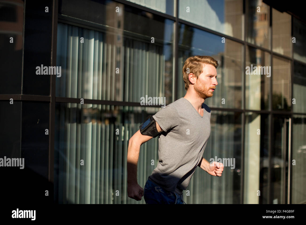 Young man running in the urban area Stock Photo - Alamy