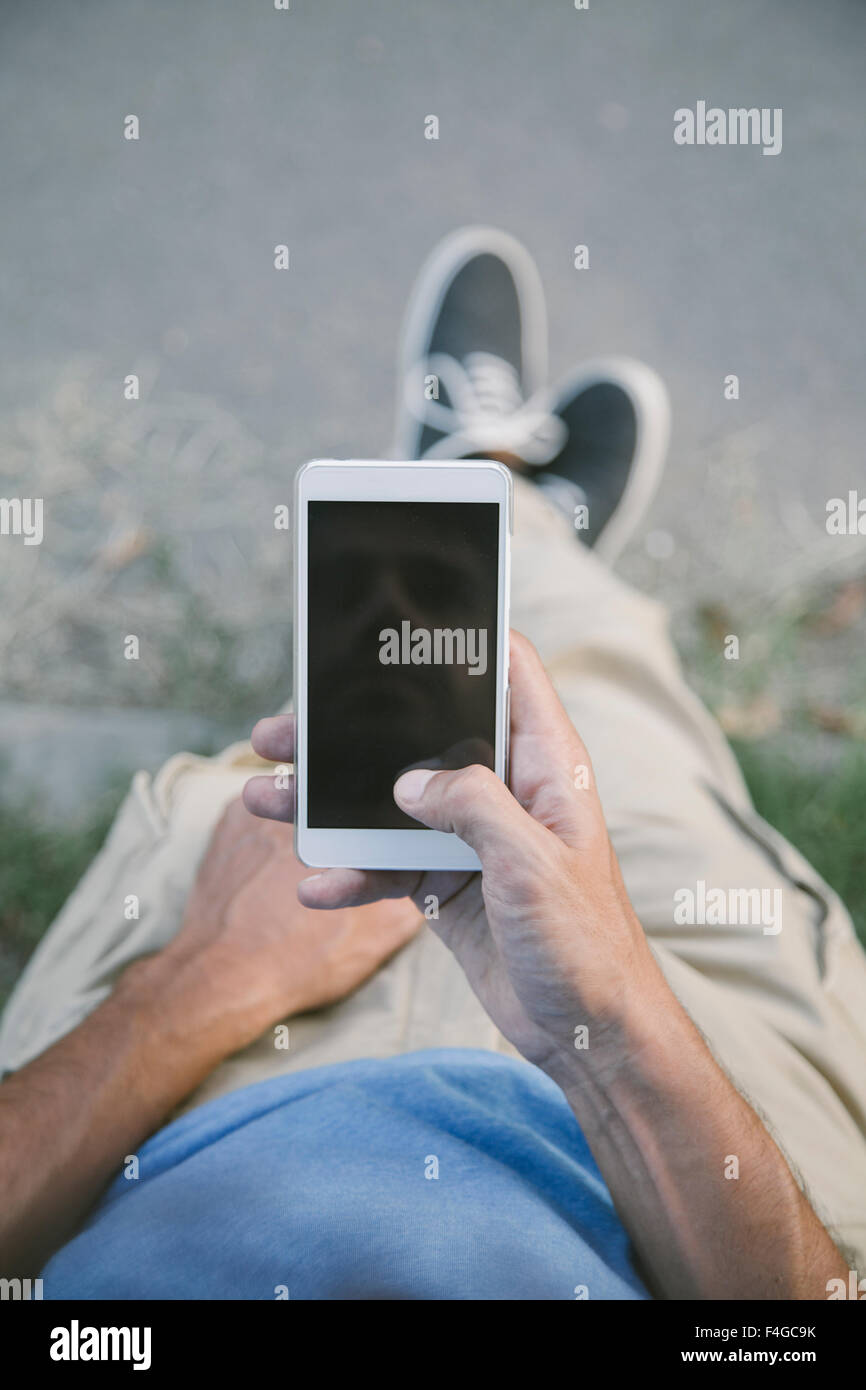 Young man with mobile phone outdoor Stock Photo - Alamy