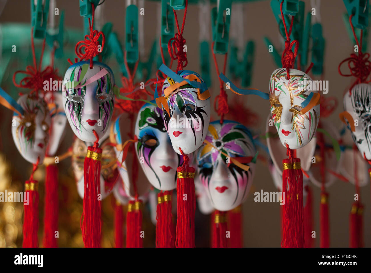 miniature chinese masks with red tassles. These are sold around ...