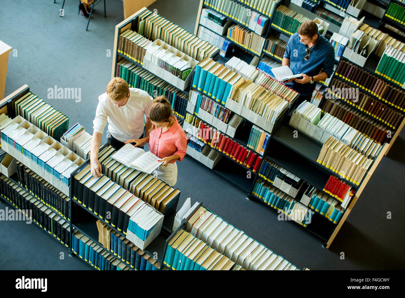 Young people in the library Stock Photo - Alamy