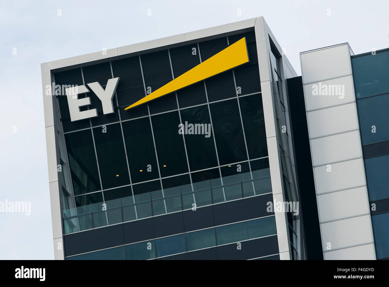 A logo sign outside of an office building occupied by Ernst & Young (EY ...