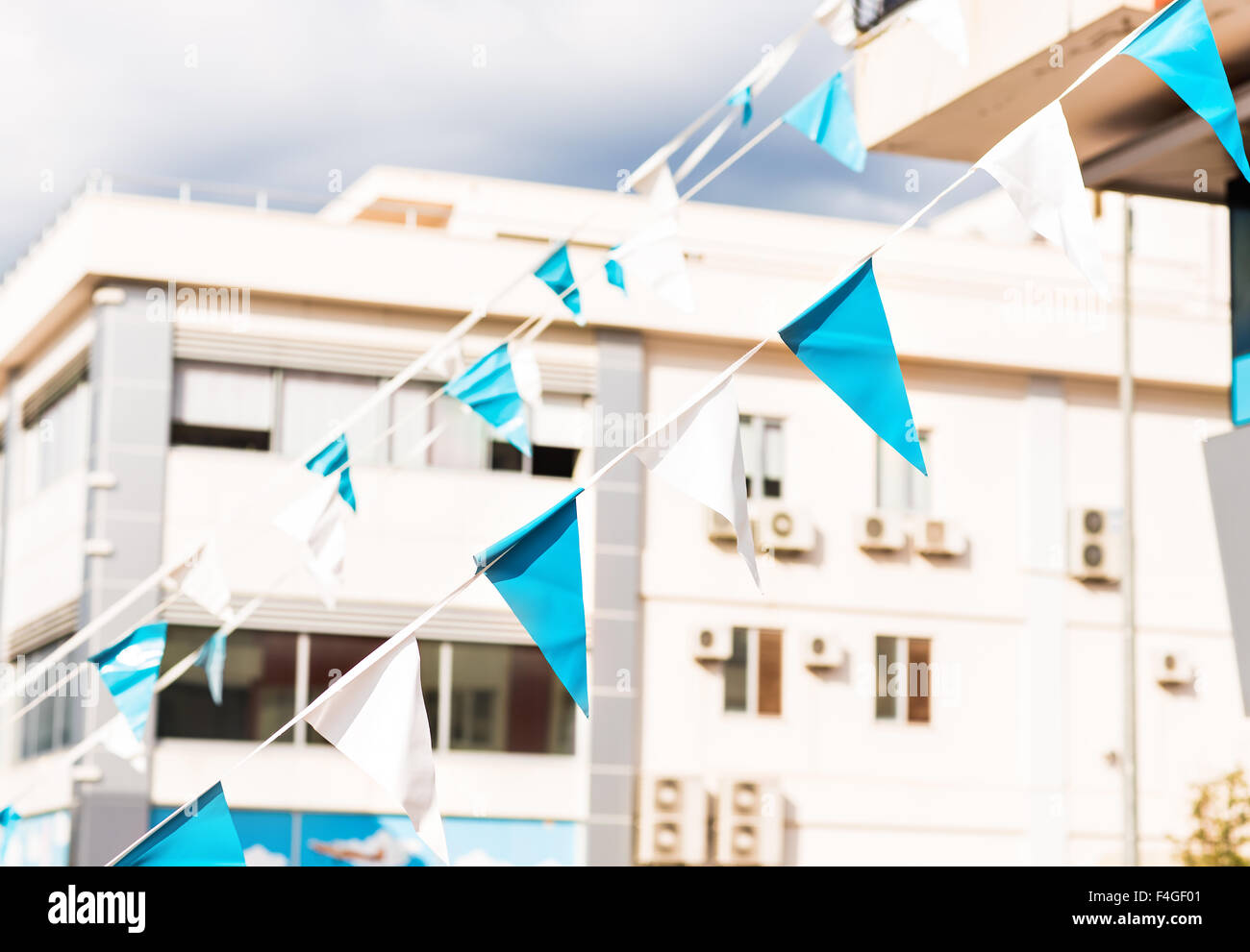 Small triangular waving flags in city Stock Photo - Alamy