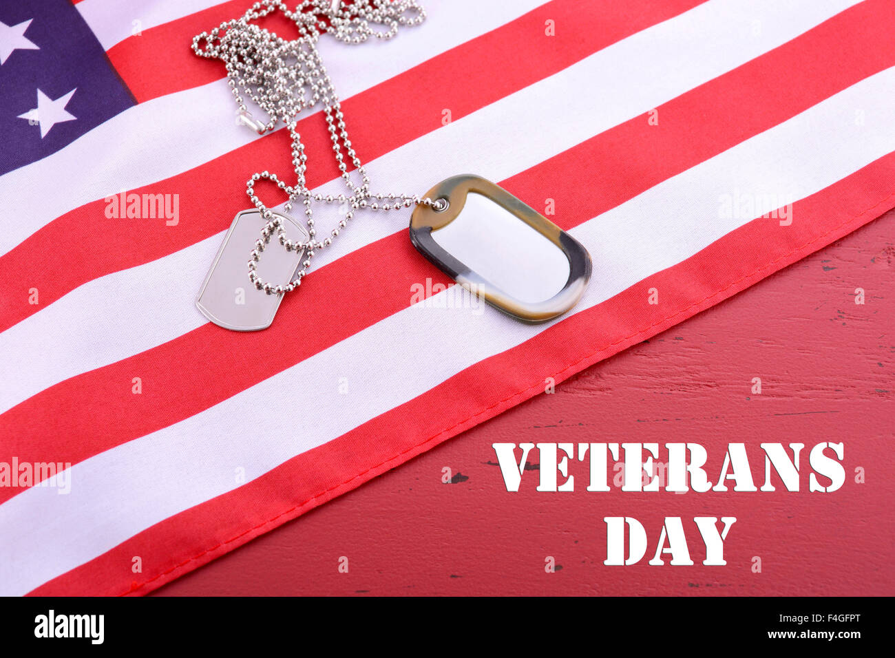 Veterans Day USA flag with dog tags on rustic red wood background with ...