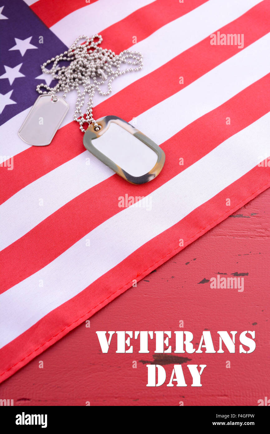 Veterans Day USA flag with dog tags on rustic red wood background with ...