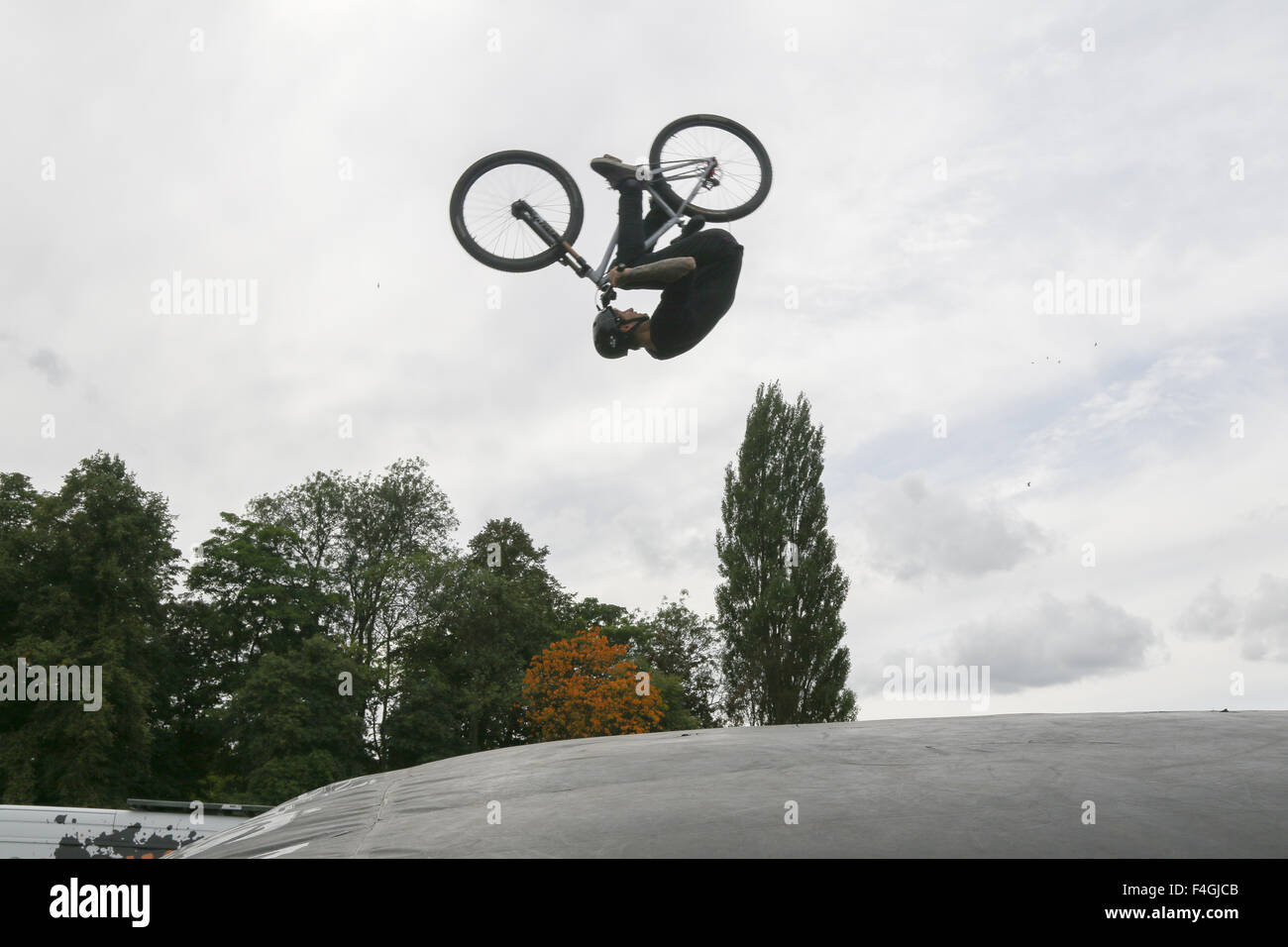 Stunt cyclist in mid air above landing cushion Stock Photo - Alamy