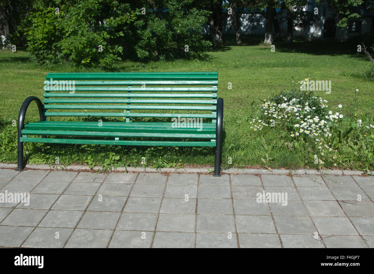 Bench in a park, grass and flowers Stock Photo - Alamy