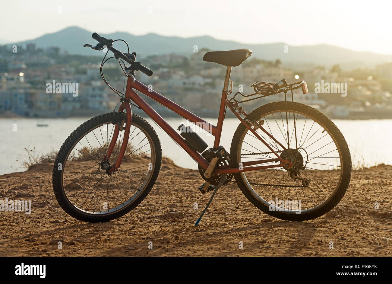 Red bicycle on the hill at sunset Stock Photo - Alamy