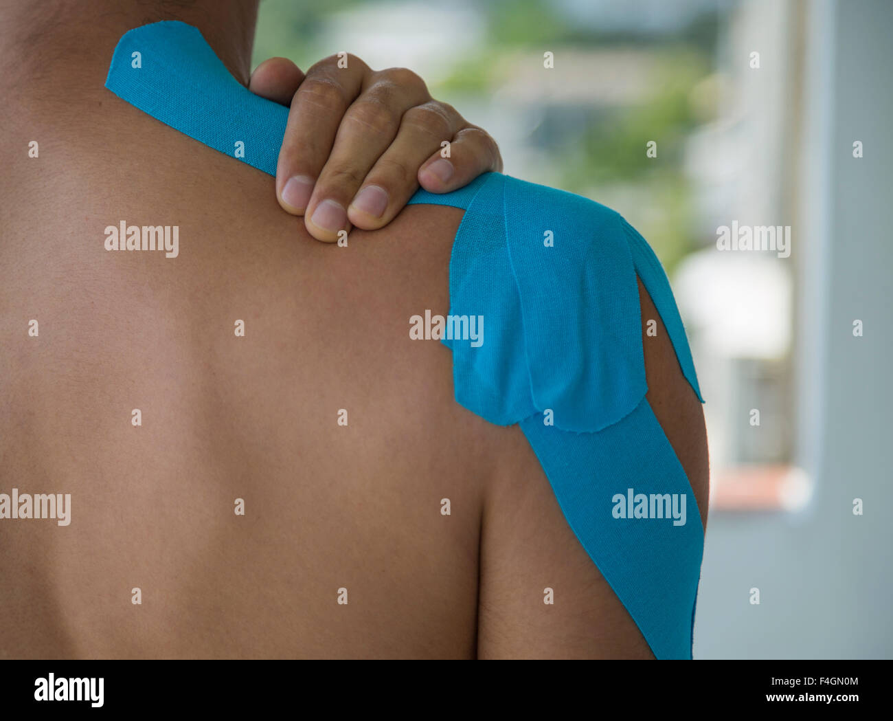 Adhesive bandage on shoulder Stock Photo - Alamy