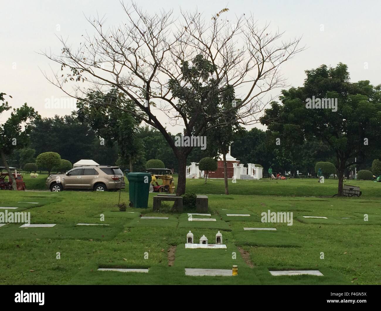 Las Pinas, Philippines. 18th Oct, 2015. Men cleaning up the tombs and ...