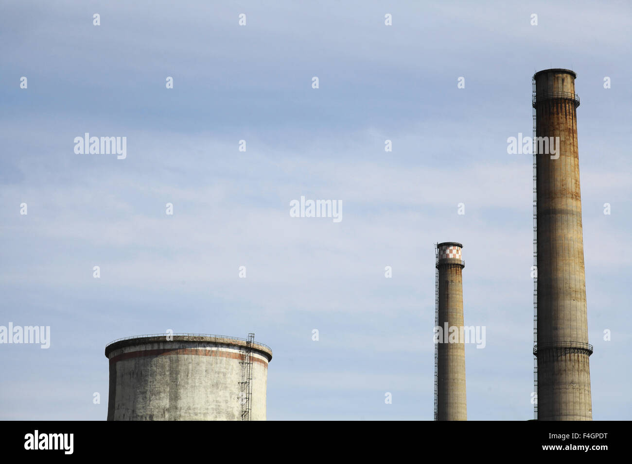 Color image of some chimneys at a factory Stock Photo - Alamy
