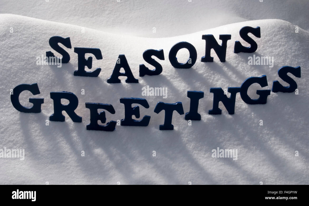 Blue Word Seasons Greetings On Snow Stock Photo - Alamy
