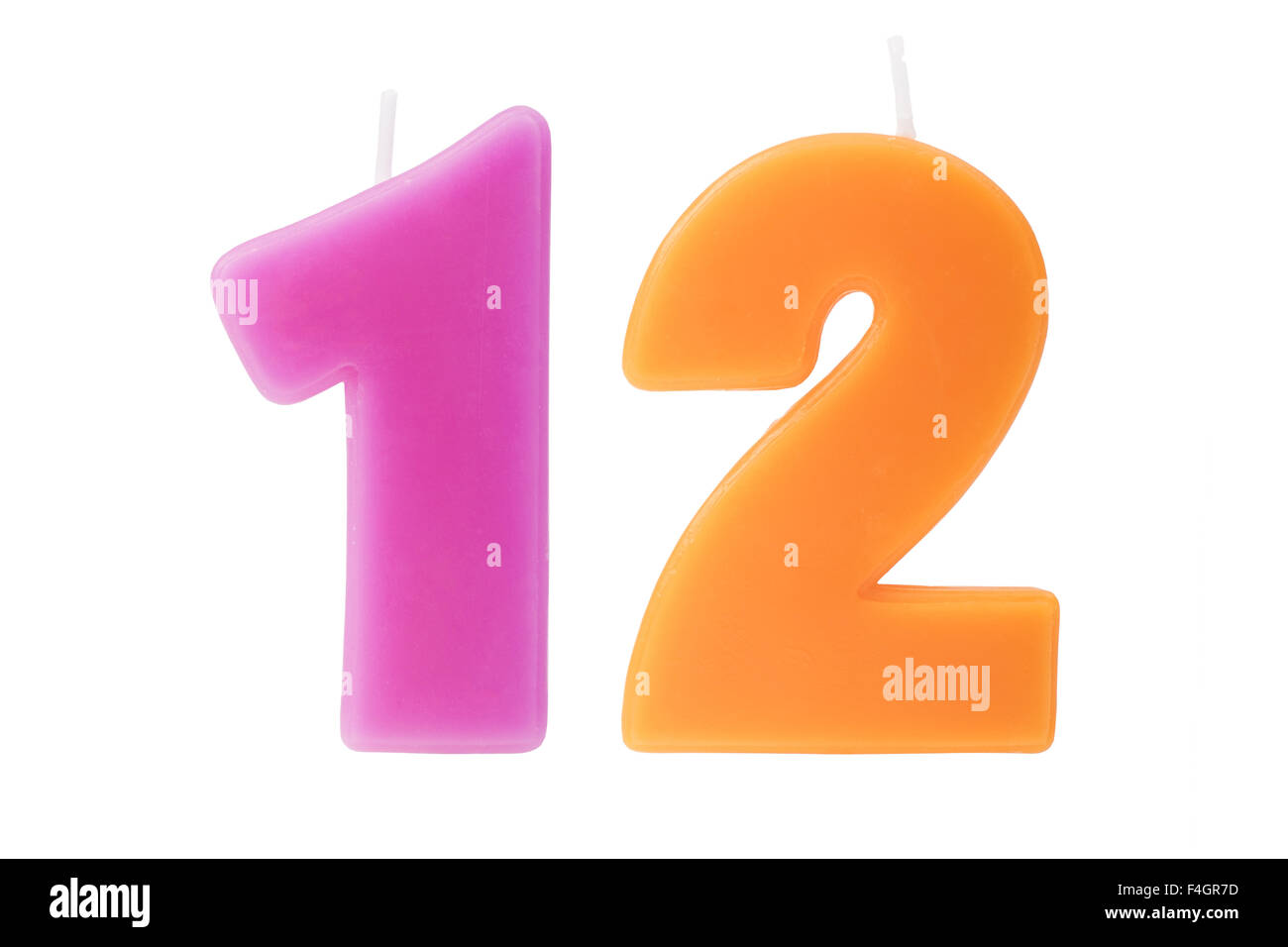 Colorful birthday candles in the form of the number twelve on white ...