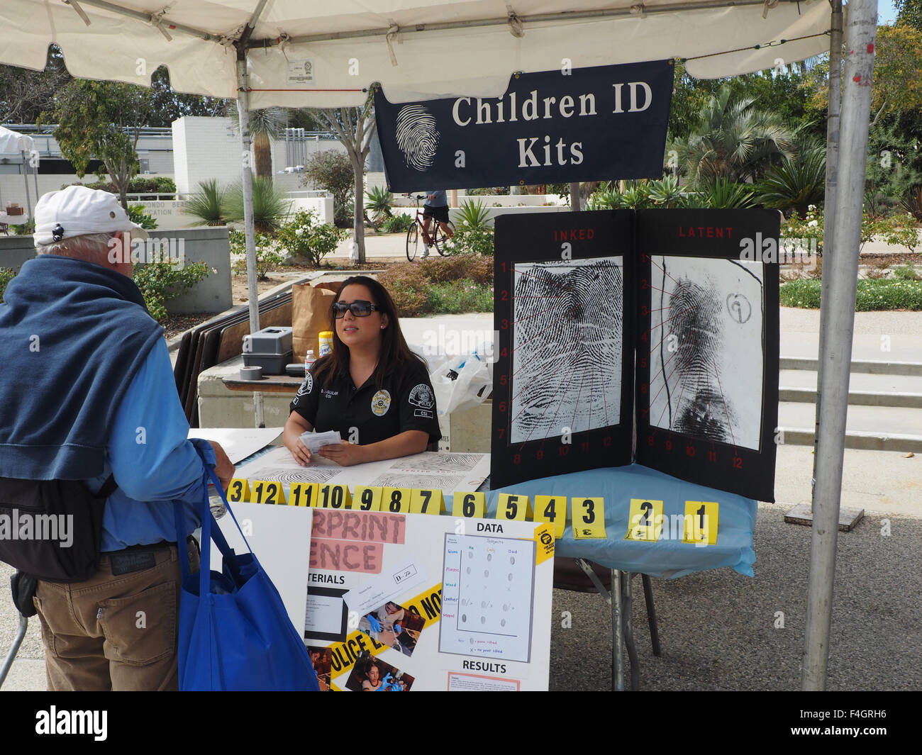 Female police officer answers questions at Children I.D. booth at the ...
