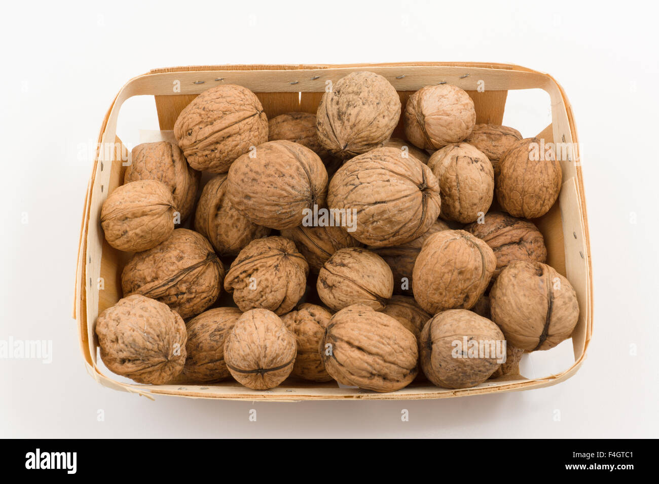 the wooden container is filled with a walnut on a white background ...