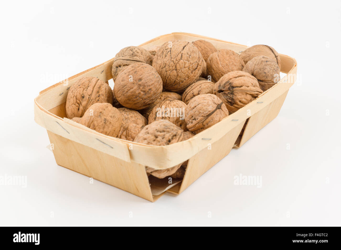 the wooden container is filled with a walnut on a white background ...